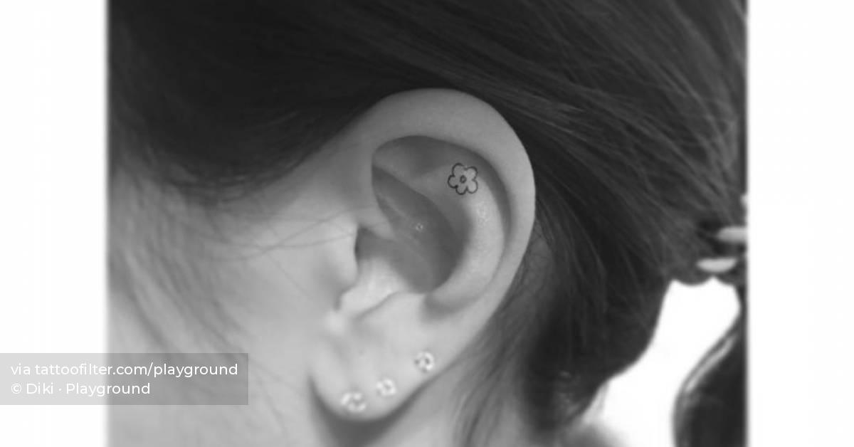 Minimalistic micro flower tattoo done on the ear.