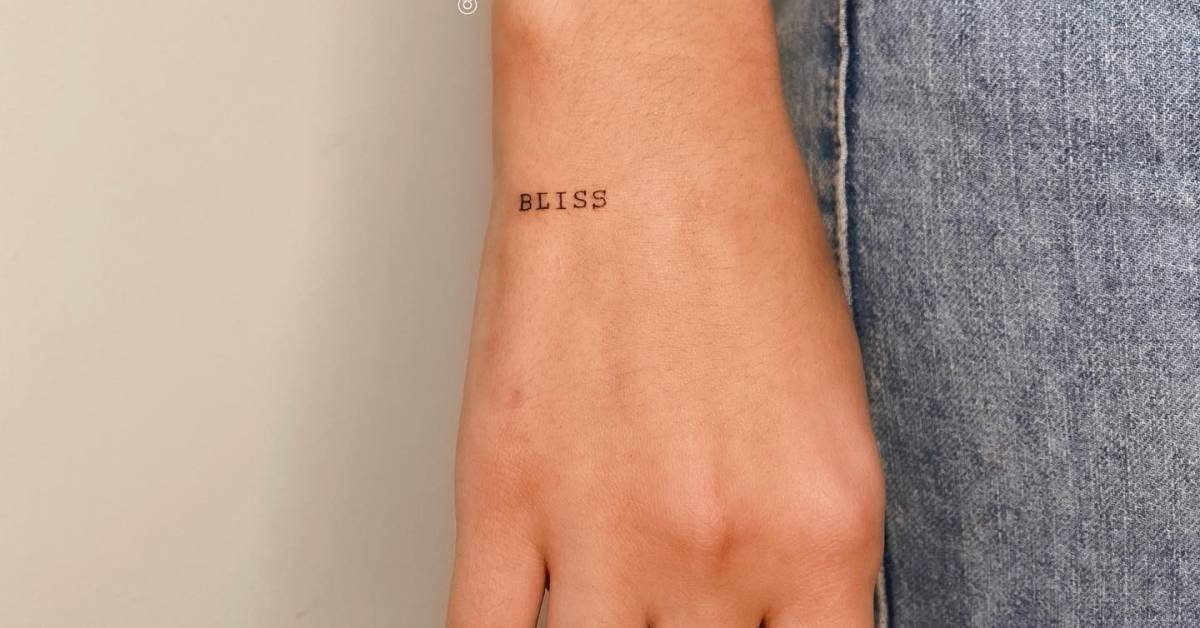 Tattoo of the word "bliss" located on the hand.