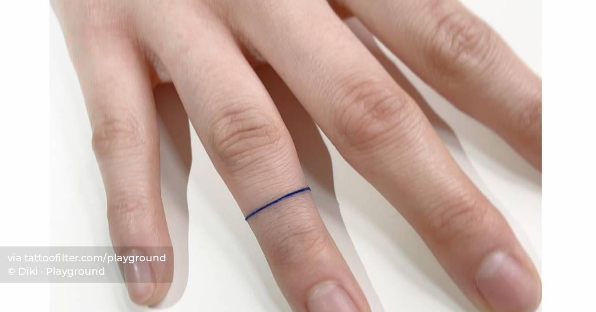 Blue ring tattoo located on the finger, minimalistic