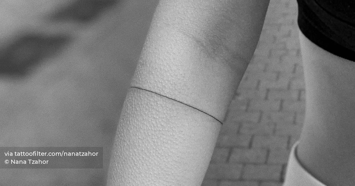 Line art armband tattoo done on the forearm.