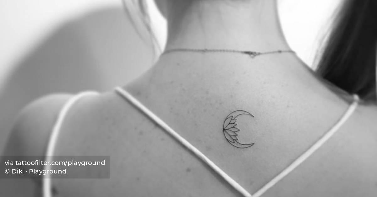 Fine line crescent moon and lotus flower tattooed on