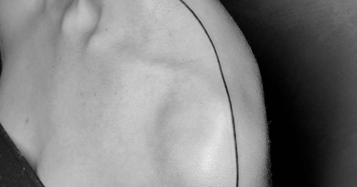 Line tattoo located on the shoulder, minimalistic