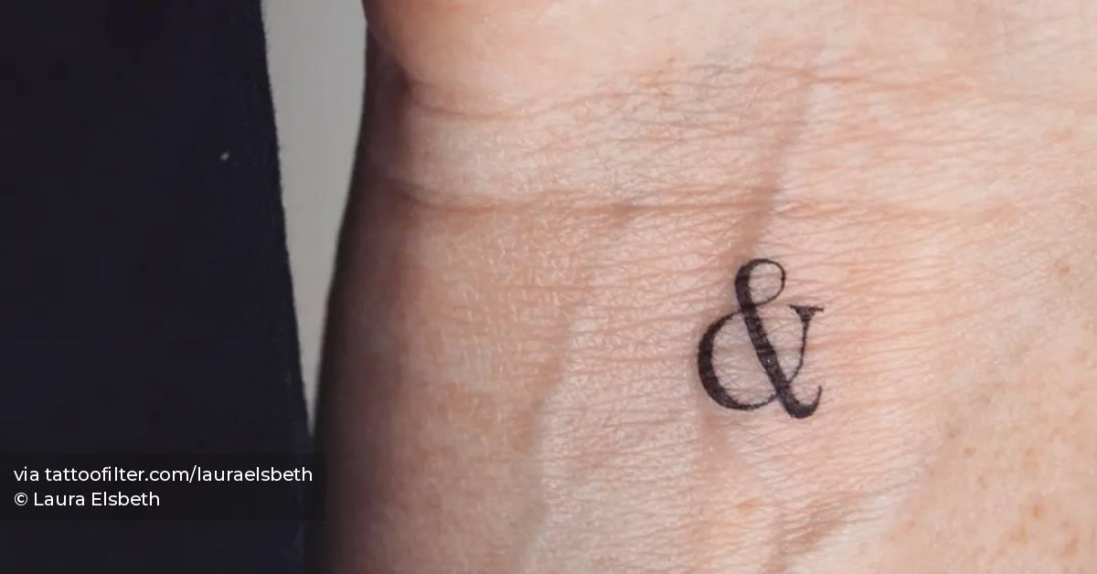 Minimalistic style ampersand tattoo done on the wrist.