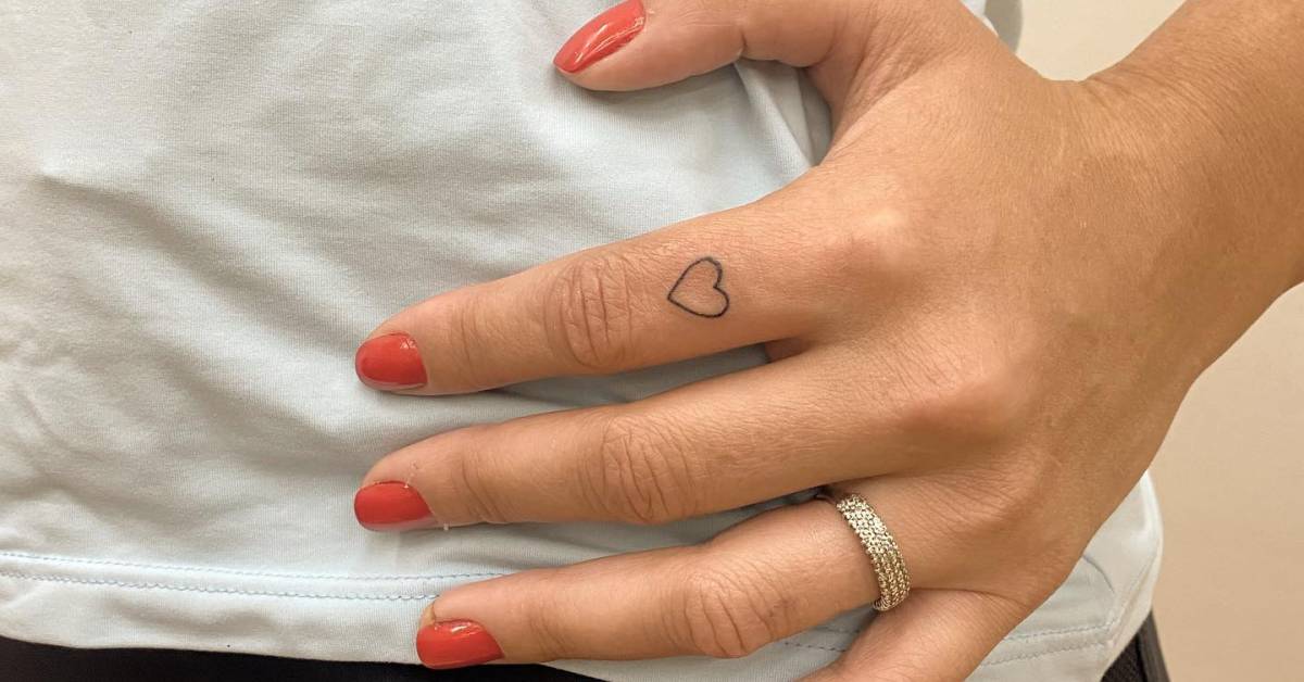 Mini heart tattoo done on the finger.