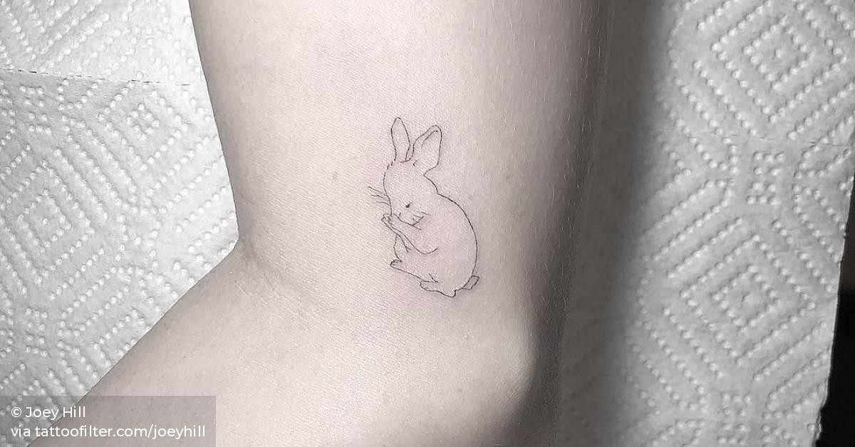 Single needle rabbit tattoo on the inner arm.