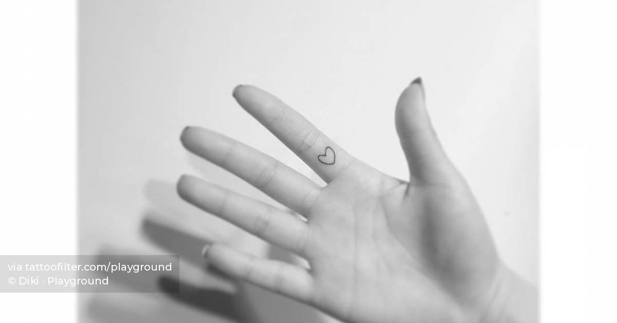 Tiny heart tattoo located on the finger, minimalistic
