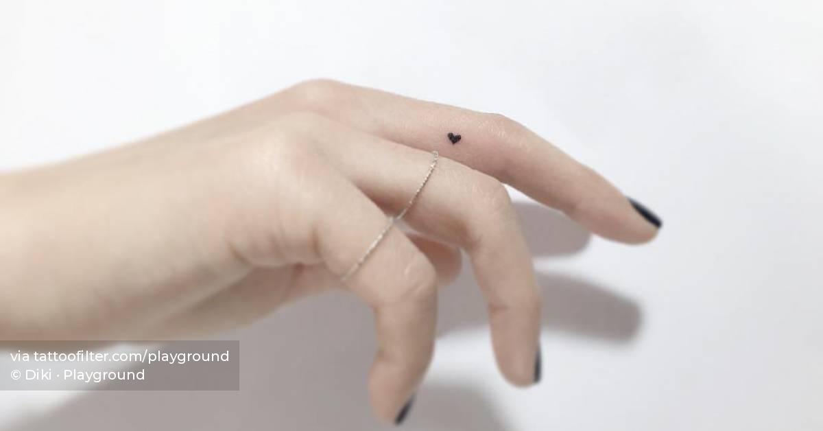 Micro heart tattoo located on the finger, minimalistic