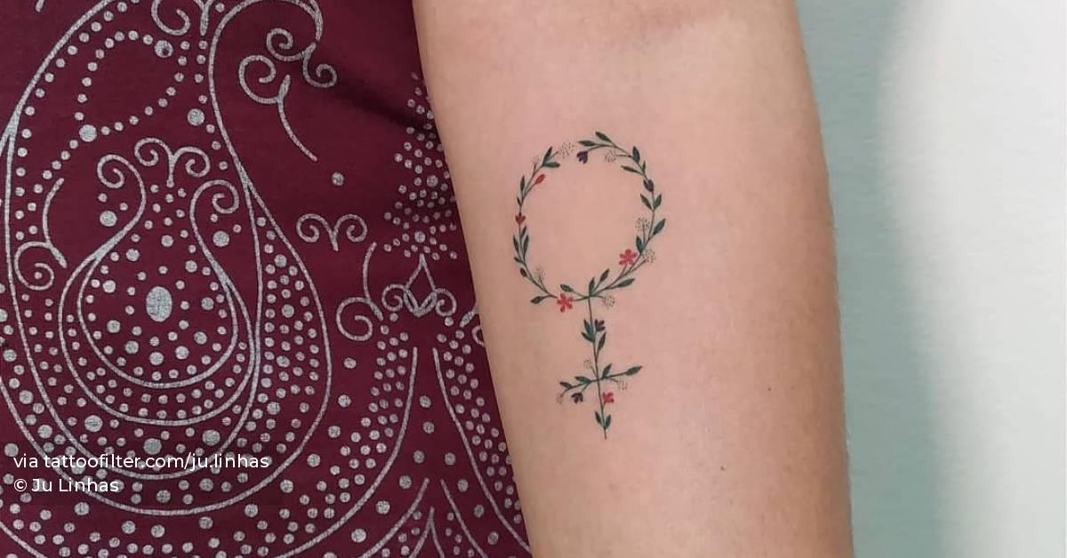 Floral venus symbol tattoo done on the inner forearm.