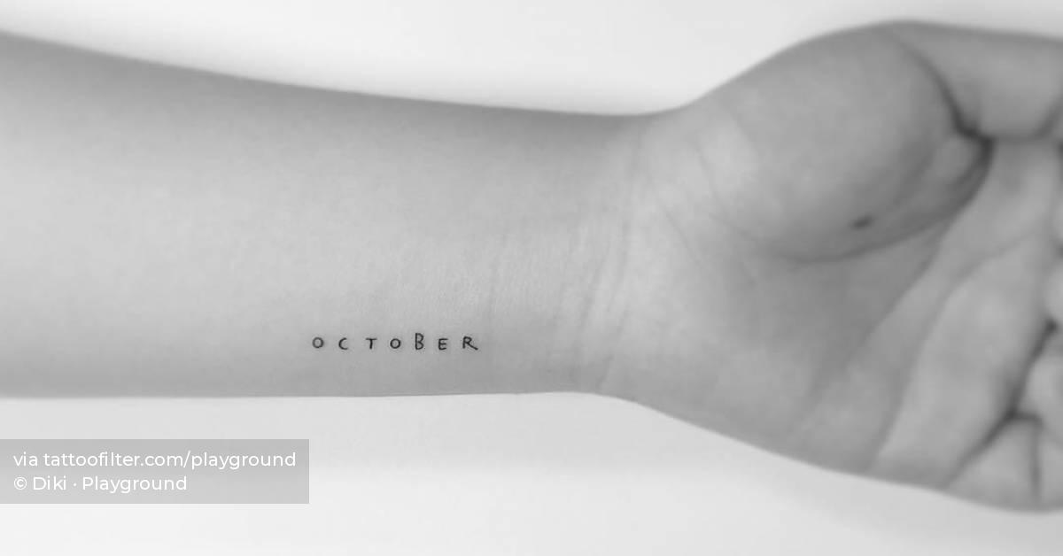 Tattoo of the word "october" located on the wrist.