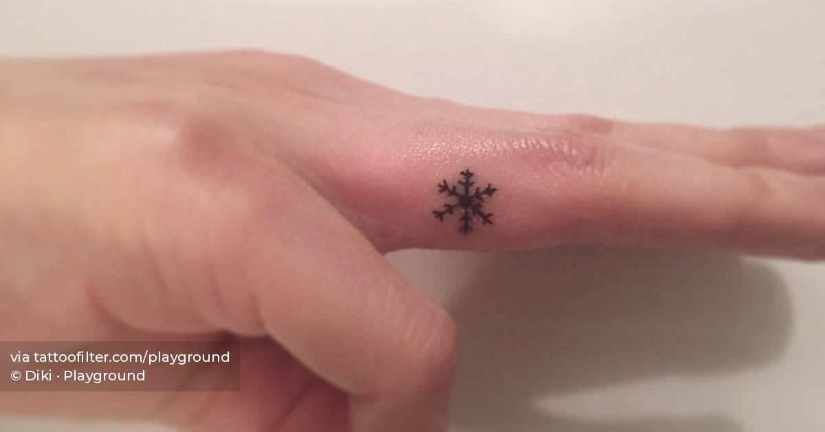 Snowflake tattoo done on the finger, minimalistic