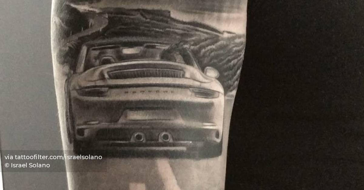 Black and grey Porsche 911 tattoo on the upper arm.
