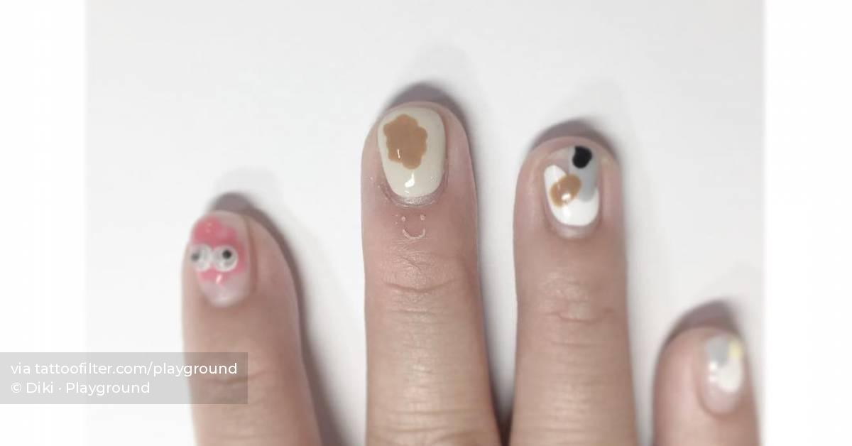 Micro smiley tattoo in white ink, done on the finger.