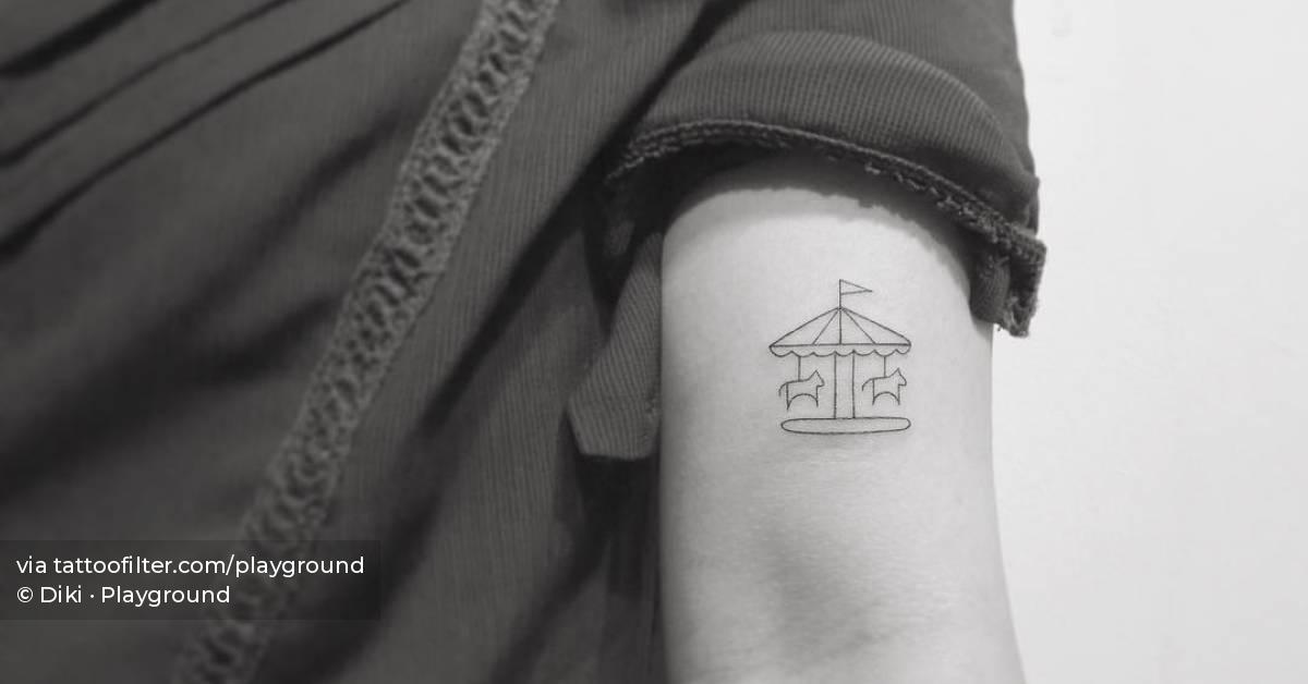 Minimalistic style carousel tattoo done on the bicep.