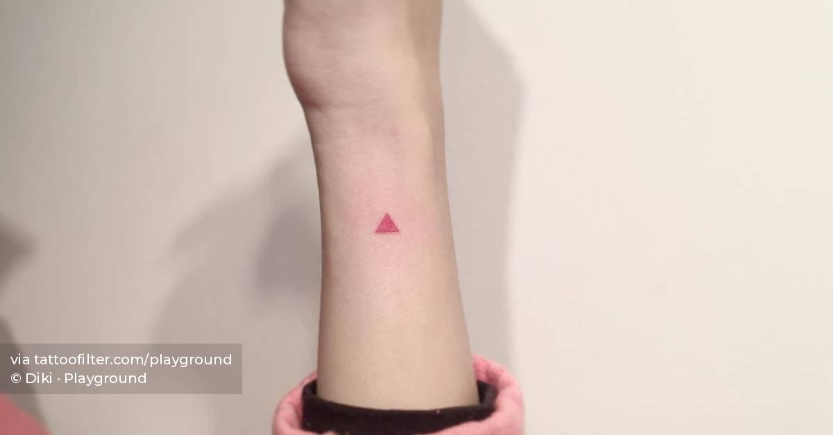 Red triangle tattoo done on the wrist.