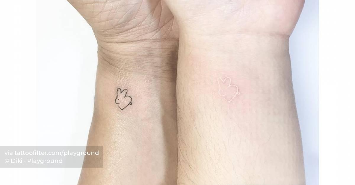 Minimalistic fine line matching rabbit tattoo for