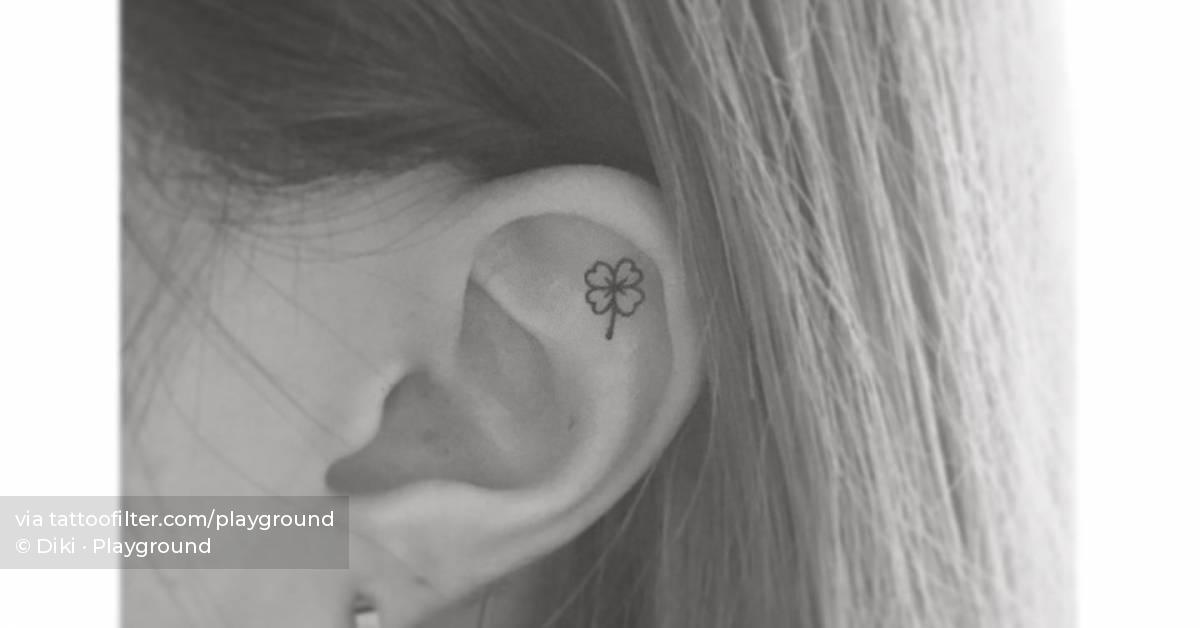 Tiny four leaf clover tattooed on the ear.
