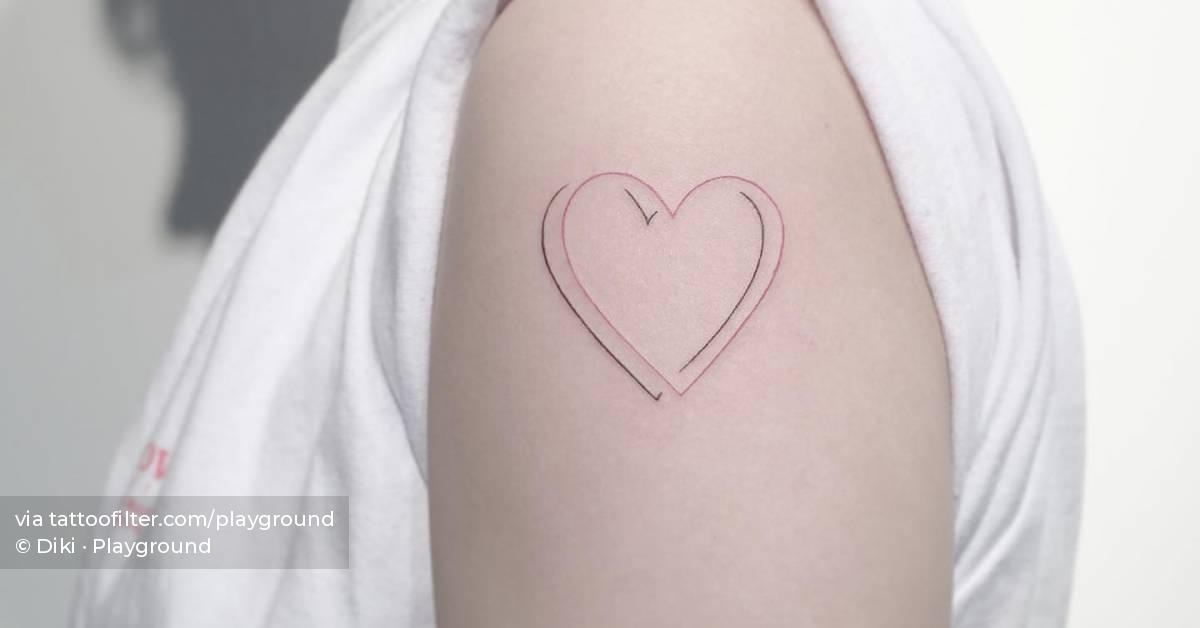 Fine line heart tattoo located on the shoulder.