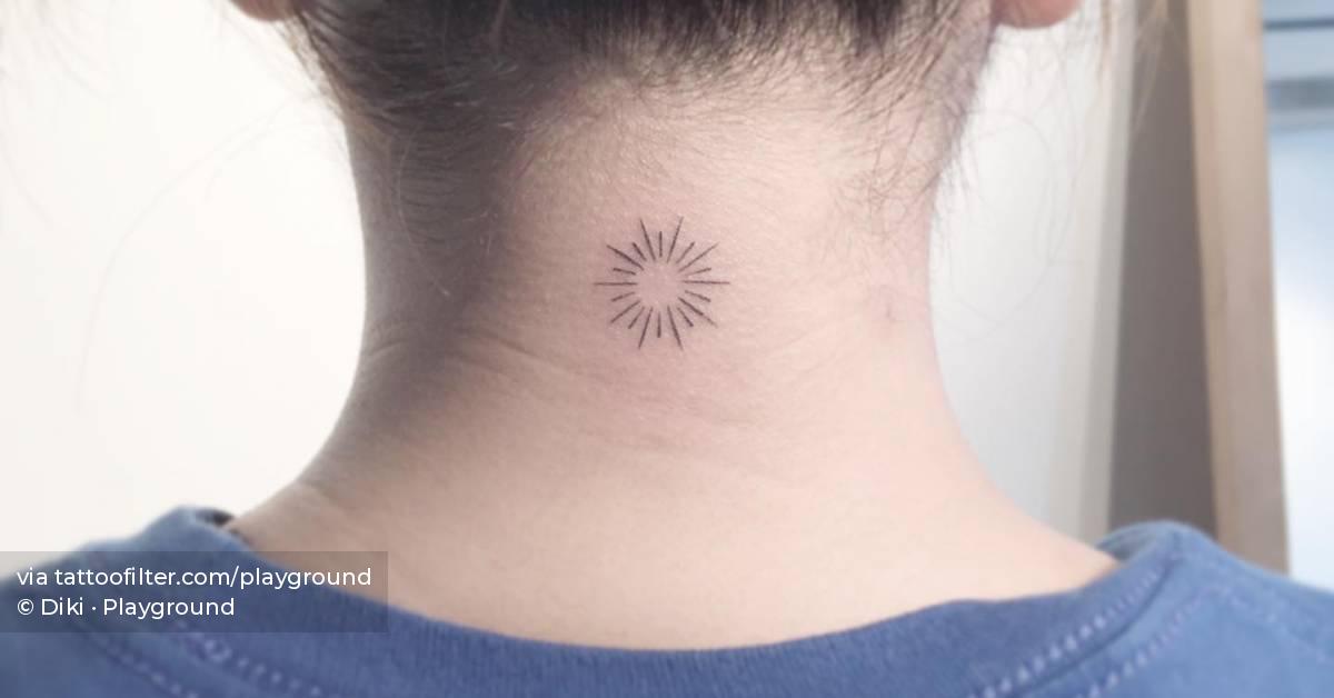 Abstract sun tattoo located on the back of the neck.