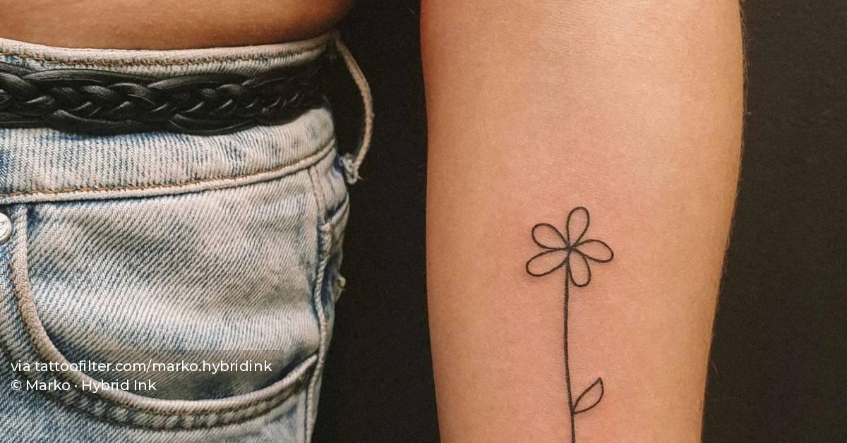 Minimalistic style flower tattoo located on the inner