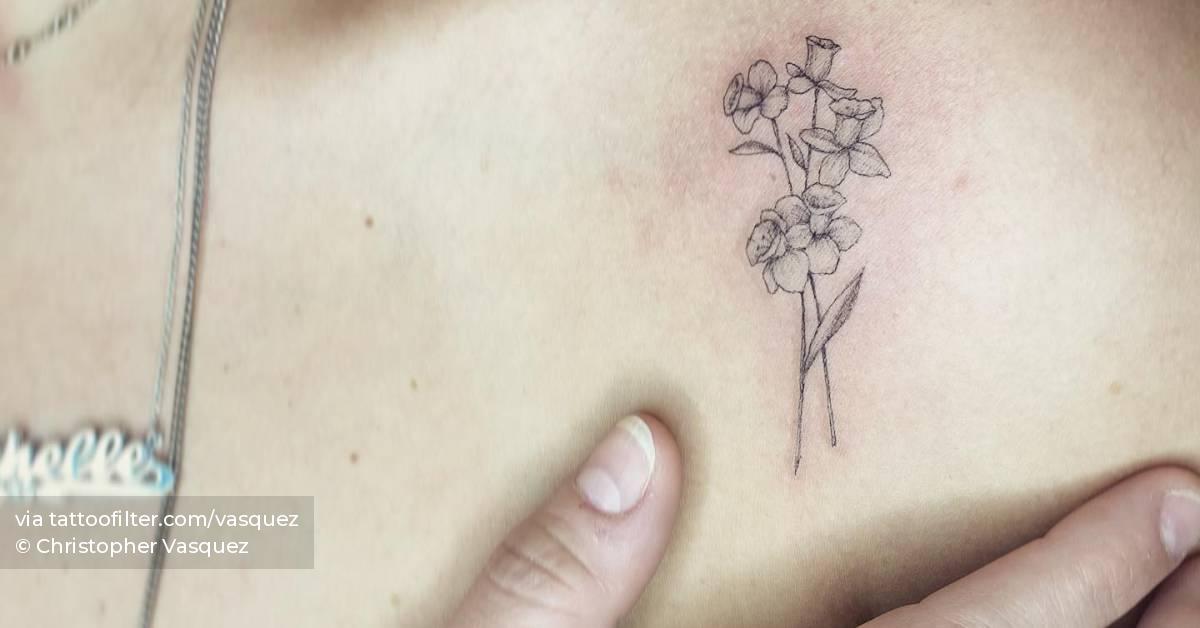 Fine line style daffodils tattoo done on the shoulder.