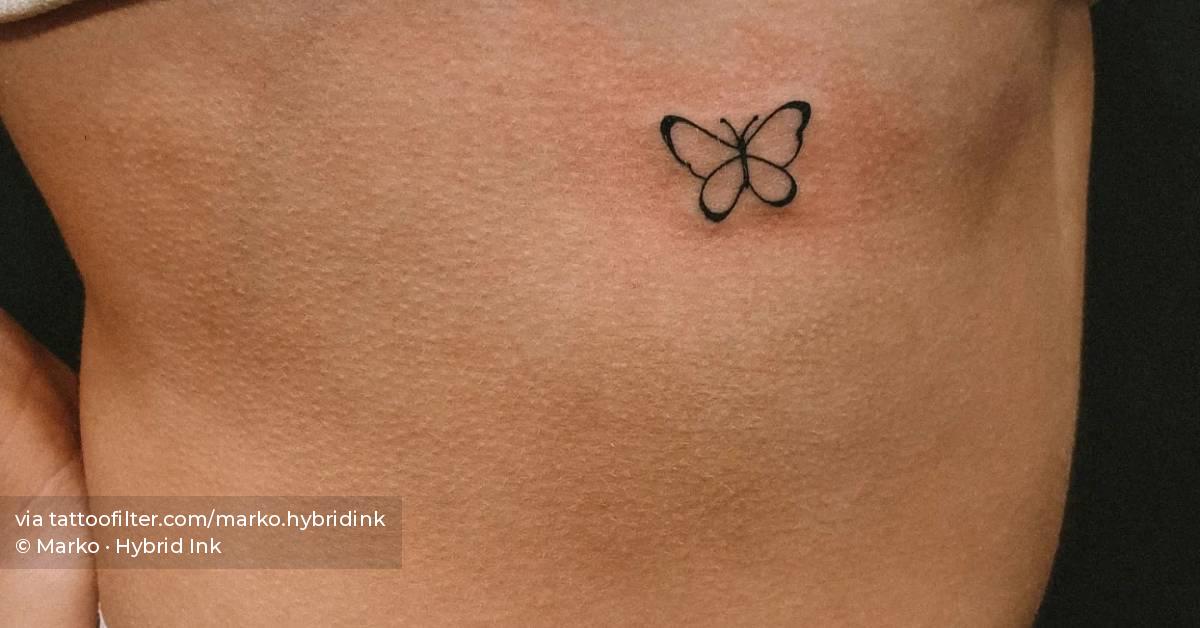 Minimalistic butterfly tattoo done on the rib.