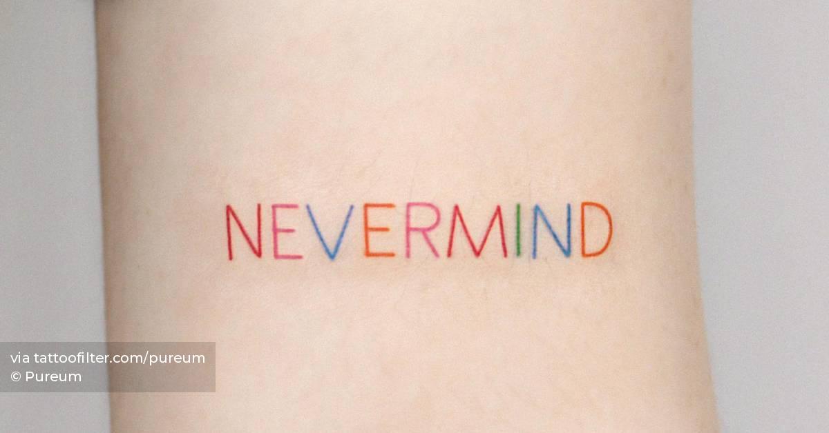 Tattoo of the word "nevermind" located on the bicep.