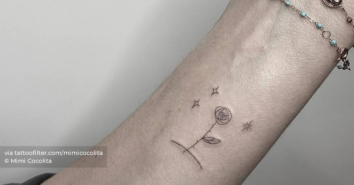 Fine line rose tattoo located on the inner forearm.
