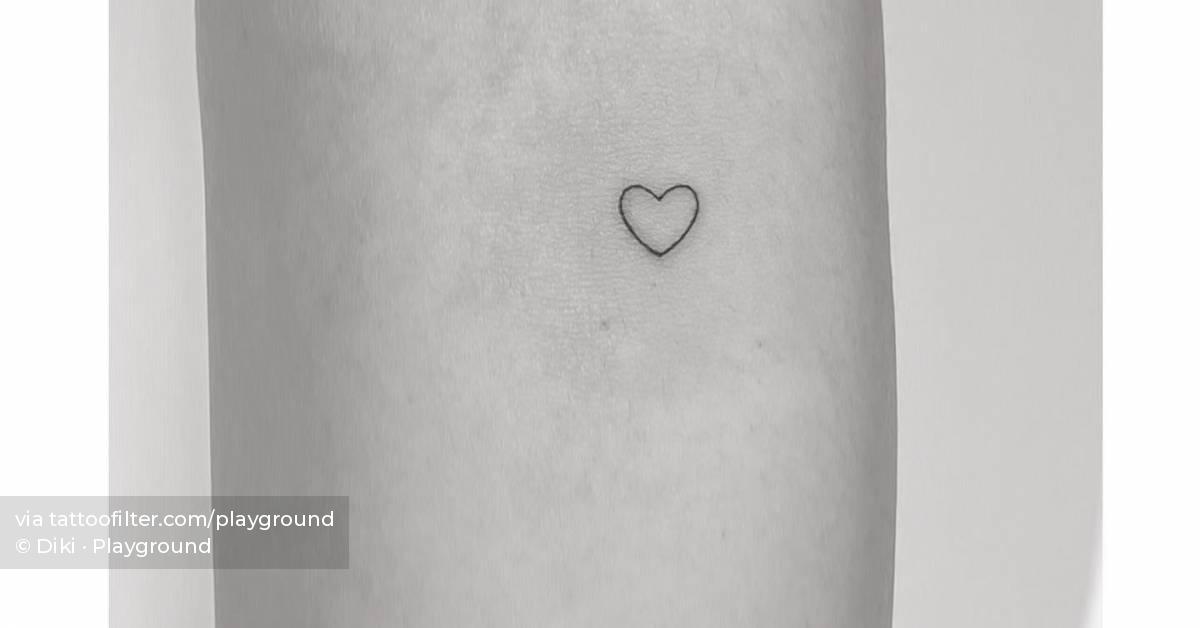 Minimalistic heart tattooed on the bicep.