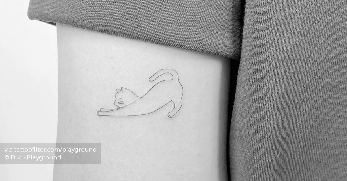 Fine line cat tattoo done on the tricep.