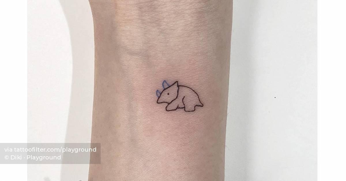 Minimalistic triceratops tattooed on the wrist.
