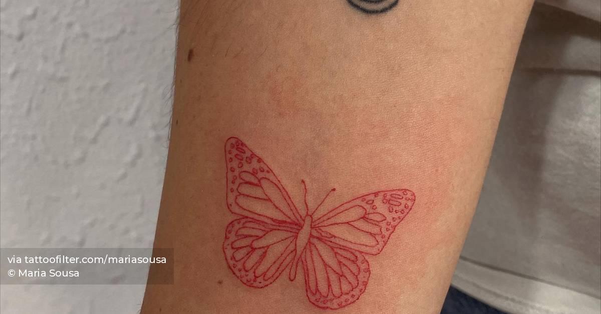 Fine line red butterfly tattoo located on the inner