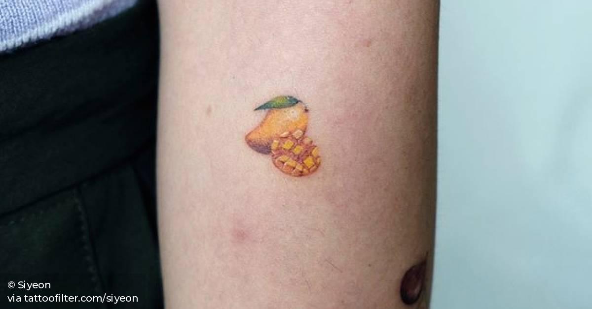 Mango tattoo on the left forearm.