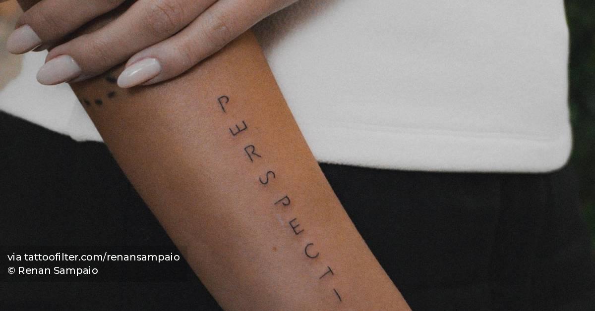 Word "perspective" tattooed on the wrist.