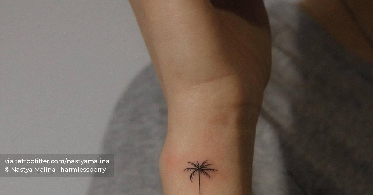 Fine line palm tree tattoo done on the wrist.