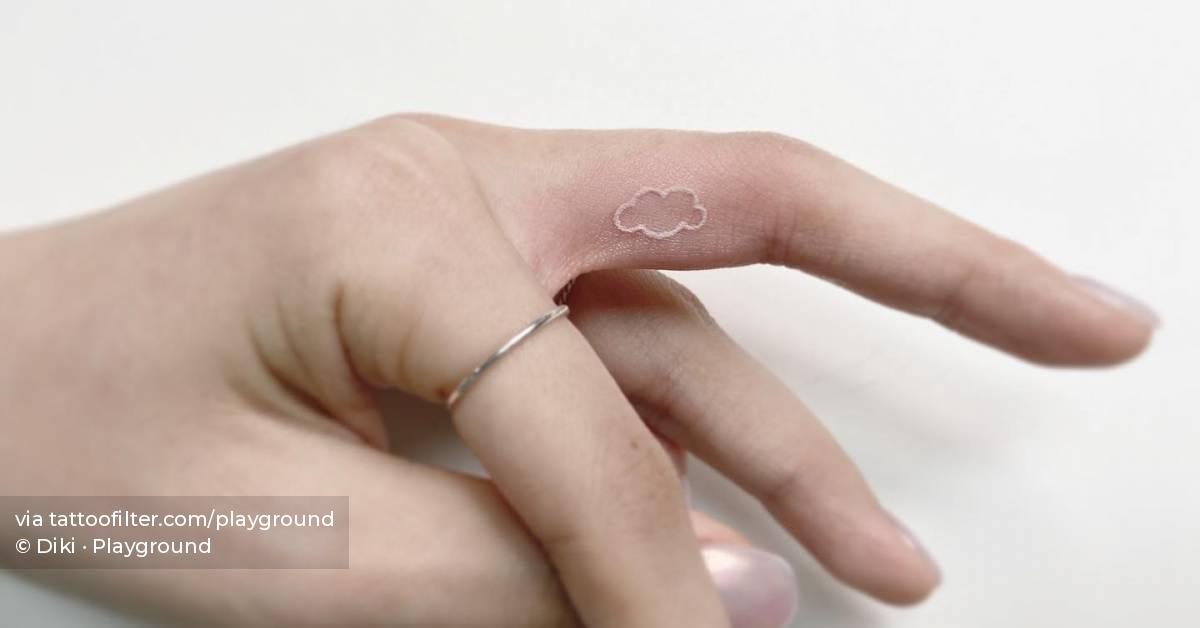 Minimalistic white cloud tattoo done on the finger.