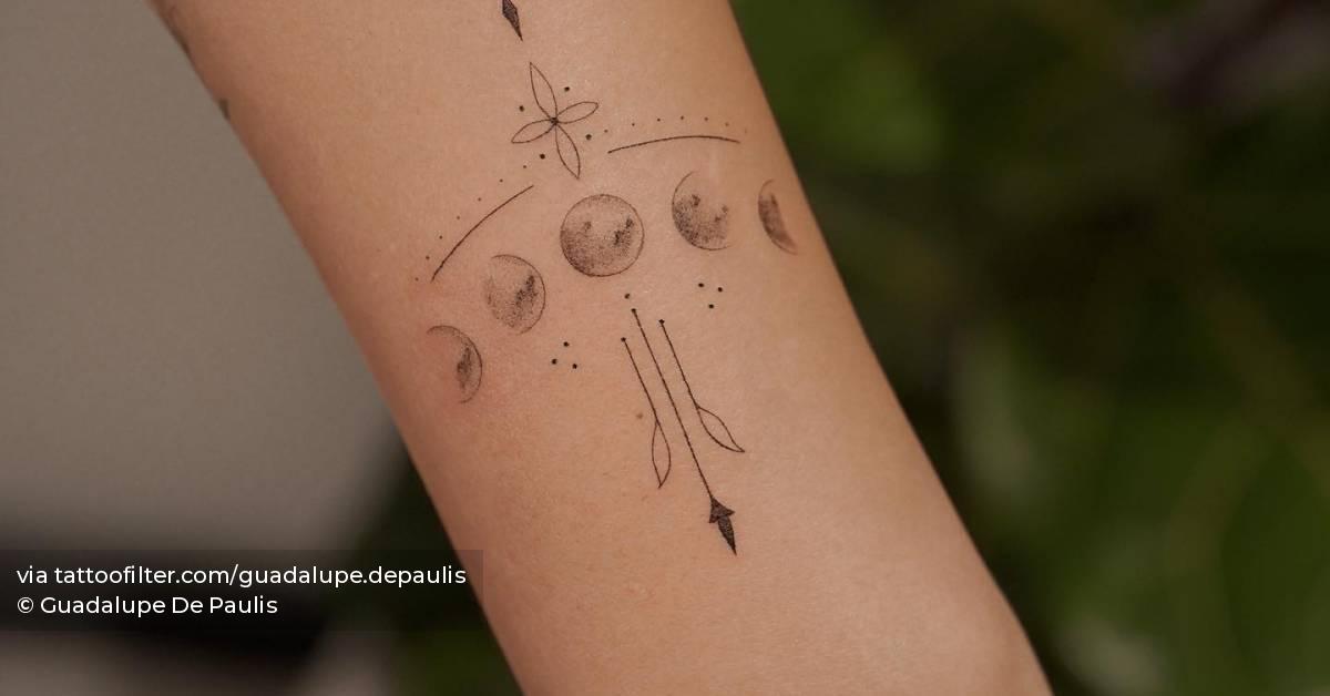 Fine line ornamental moon phases tattoo located on the