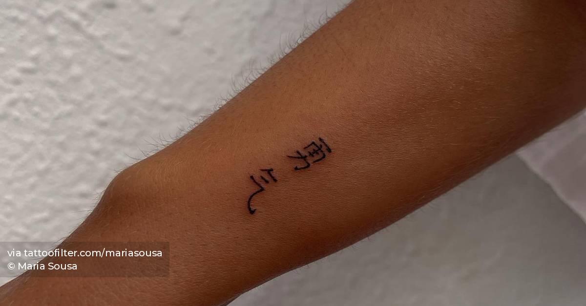 Chinese characters tattooed on the wrist.