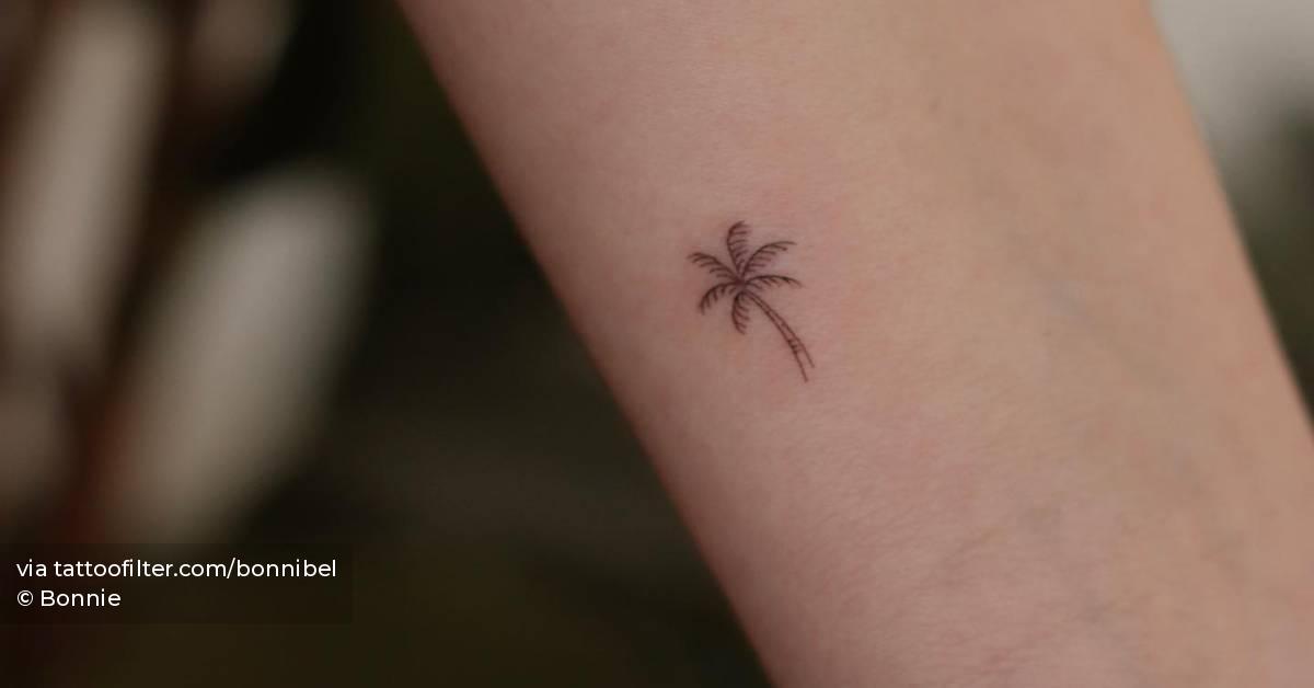 Delicate fine line palm tree tattoo located on the