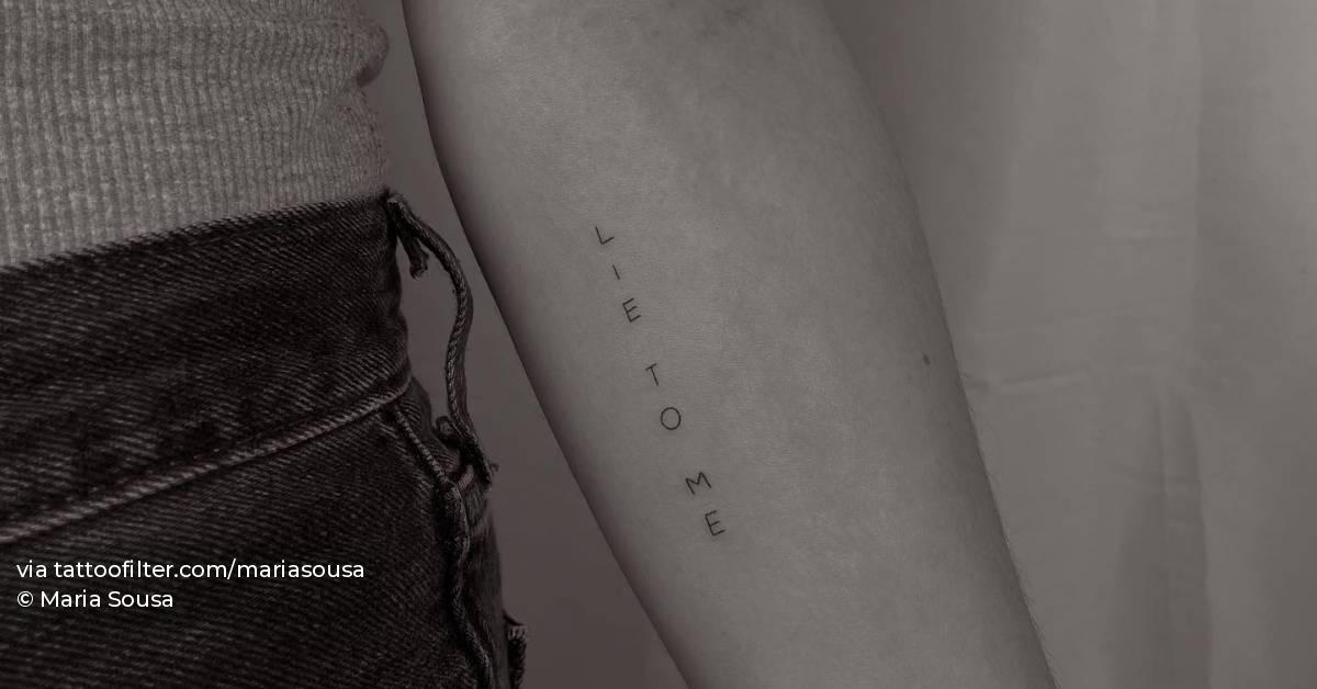 "Lie to me" lettering tattoo located on the inner