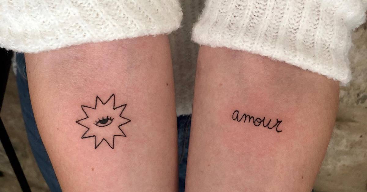 Tattoos of an eye and the word "amour" located on the