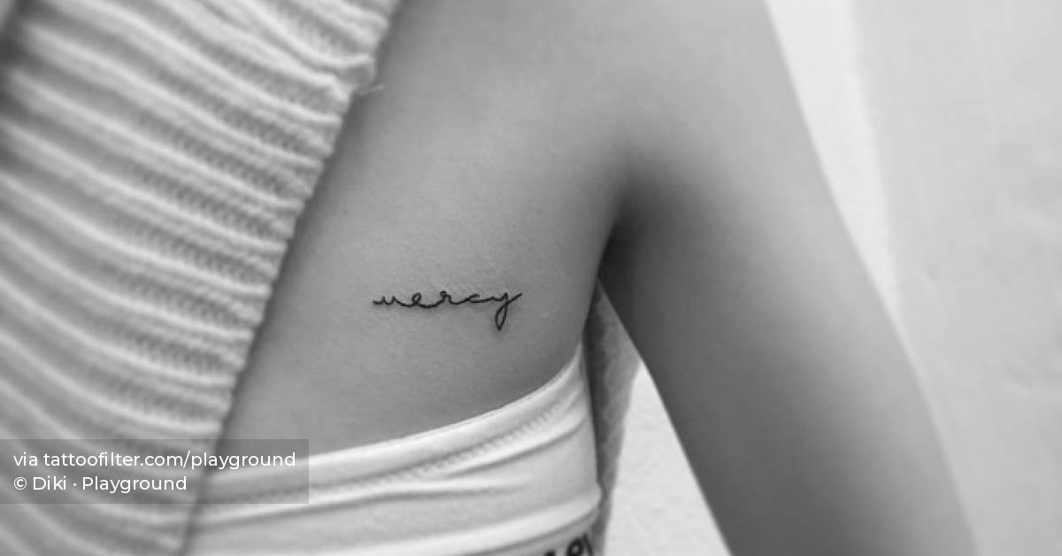 Tattoo of the word "mercy" located on the shoulder