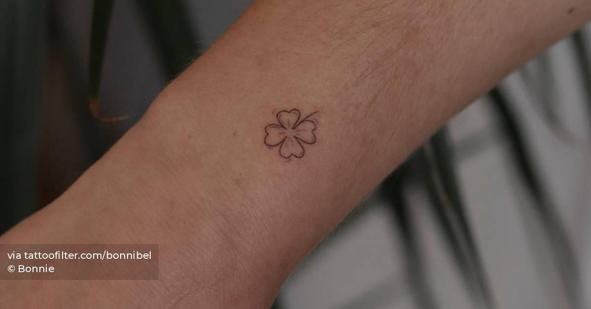 Fine line four leaf clover tattoo located on the wrist.