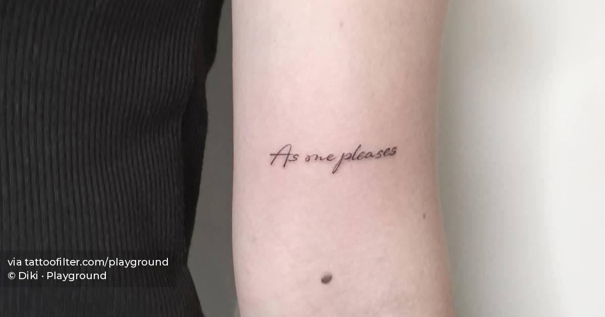 Tattoo that says "as one pleases" located on the bicep.