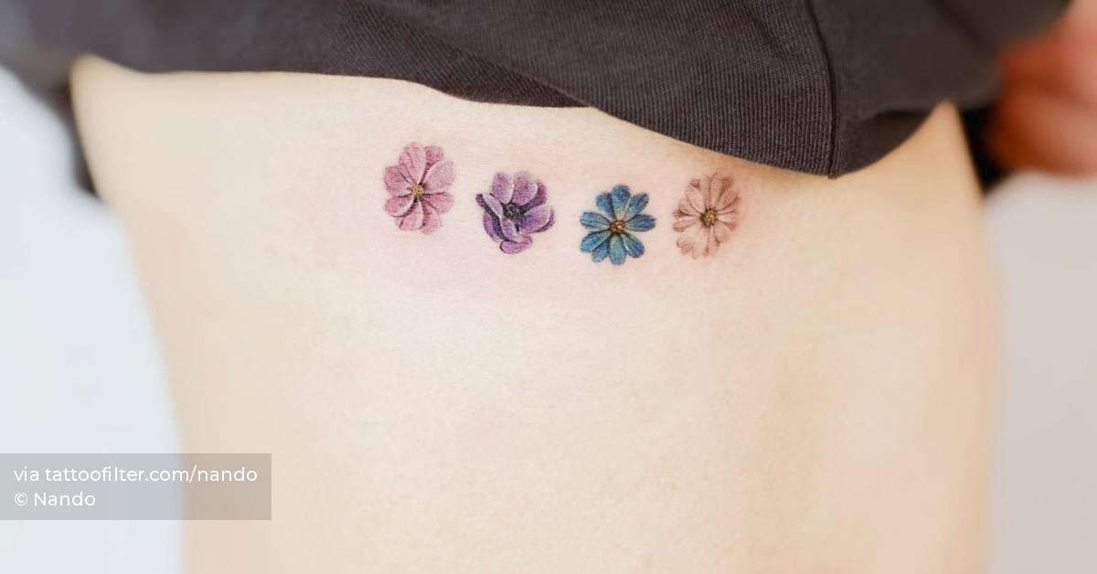 Micro-realistic flowers tattooed on the rib.