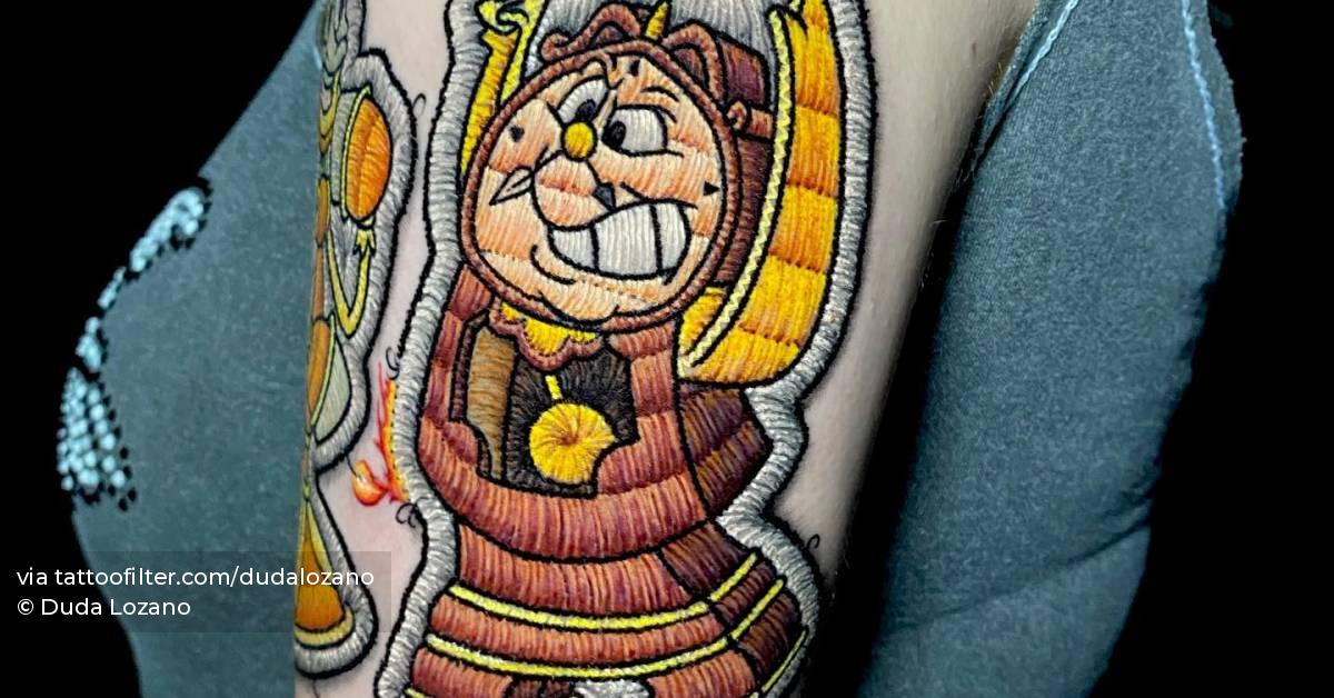Embroidery style Cogsworth patch tattoo located on the