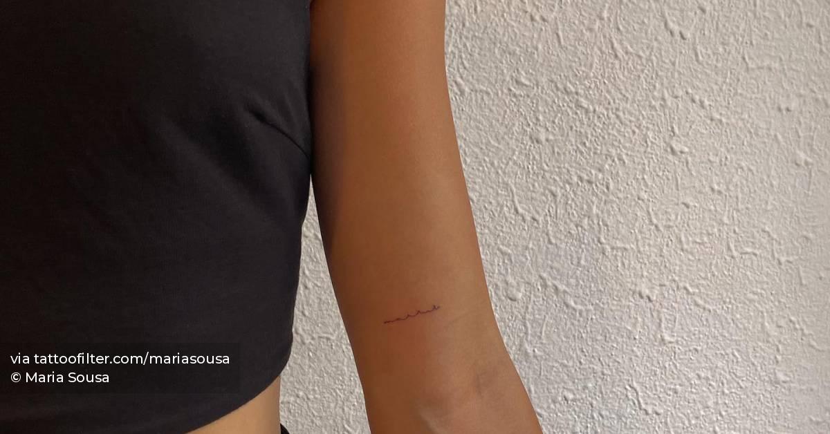 Lettering tattoo handwritten on the inner arm.