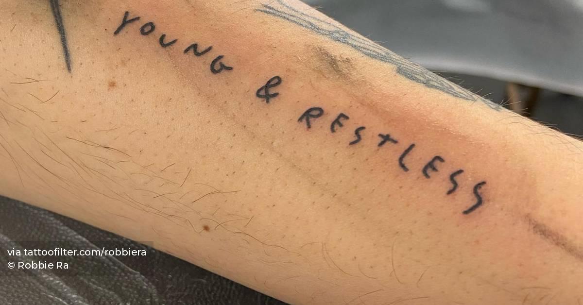 "Young and restless" lettering tattoo hand poked on the