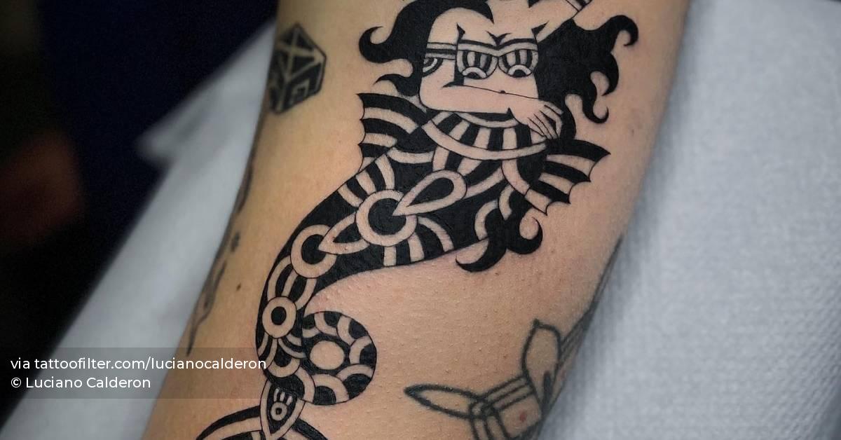 She-devil mermaid tattoo located on the inner arm.