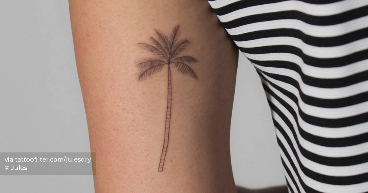 Fine line palm tree tattoo located on the tricep.