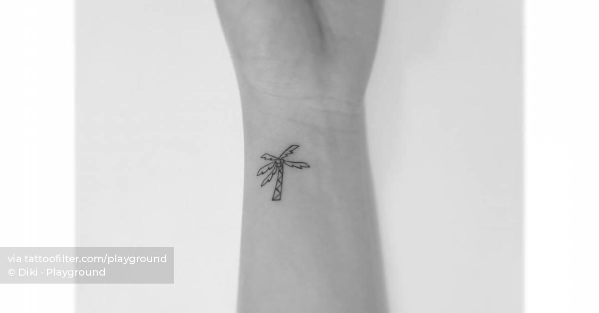Fine line palm tree tattoo located on the wrist.